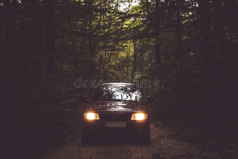 Car driving into a forest. stock image. Image of slippery - 187560957