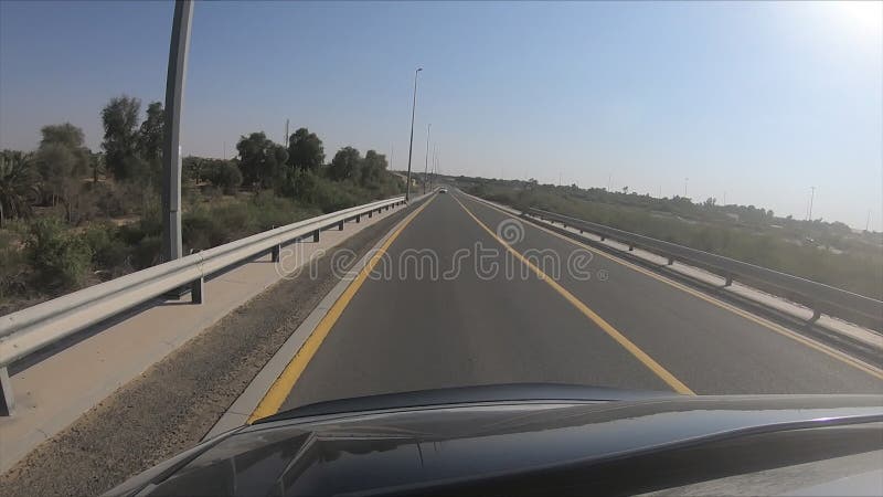 Car is Driving through Oasis, Car Rear Window Camera. Dubai Stock ...