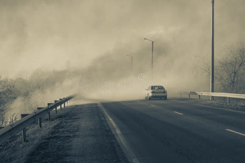 A Car Driving on a Suburban Highway during a Fire on the Side of the ...