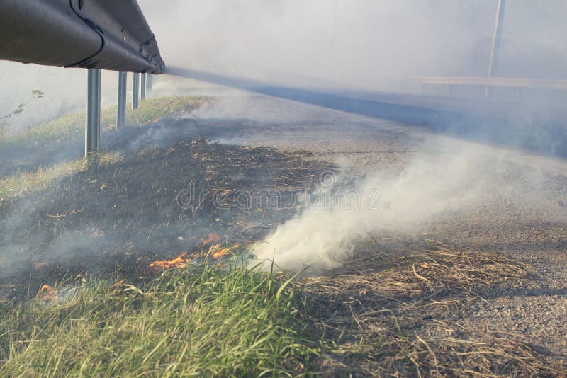 A Car Driving on a Suburban Highway during a Fire on the Side of the ...