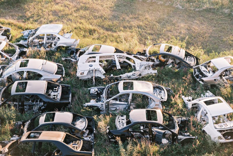 Car Dump. Broken Old Rusty Cars Lying on the Grass Stock Photo - Image ...