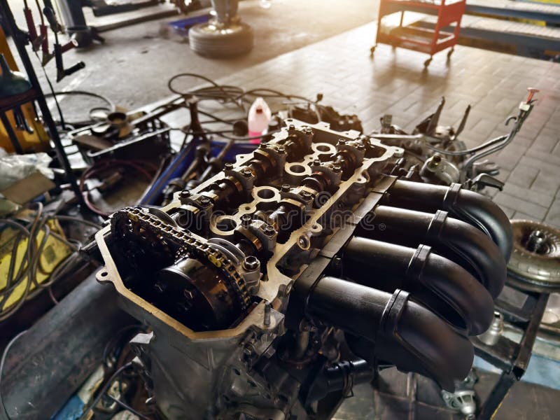 A Car Engine is Being Worked on Inside a Garage Workshop Stock Image ...