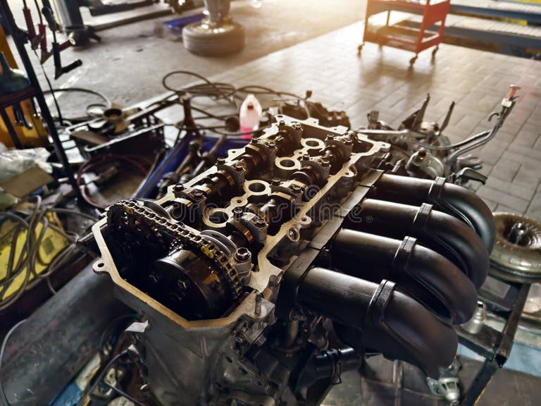 A Car Engine is Being Worked on Inside a Garage Workshop Stock Image ...
