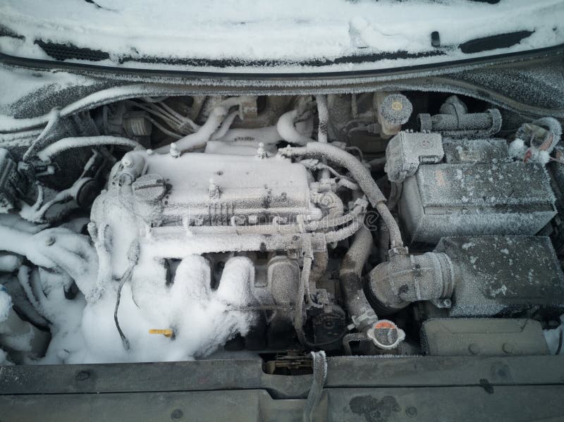 Car Engine Close-up. the Engine Compartment is Covered with Snow and ...
