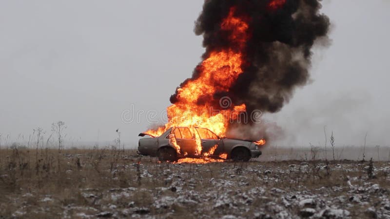 Car Explosion, Side View, Car Burns in a Gray Field Stock Footage ...