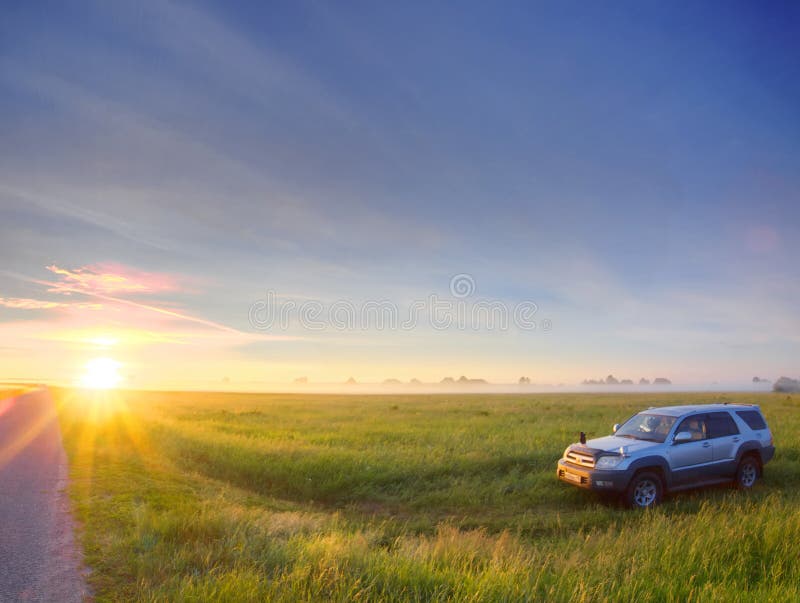 Car in field on sunset stock photo. Image of cloud, dusk - 20575264