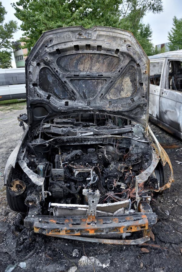 The Car after the Fire. Burnt Out Car with an Open Hood. Engine Burned ...