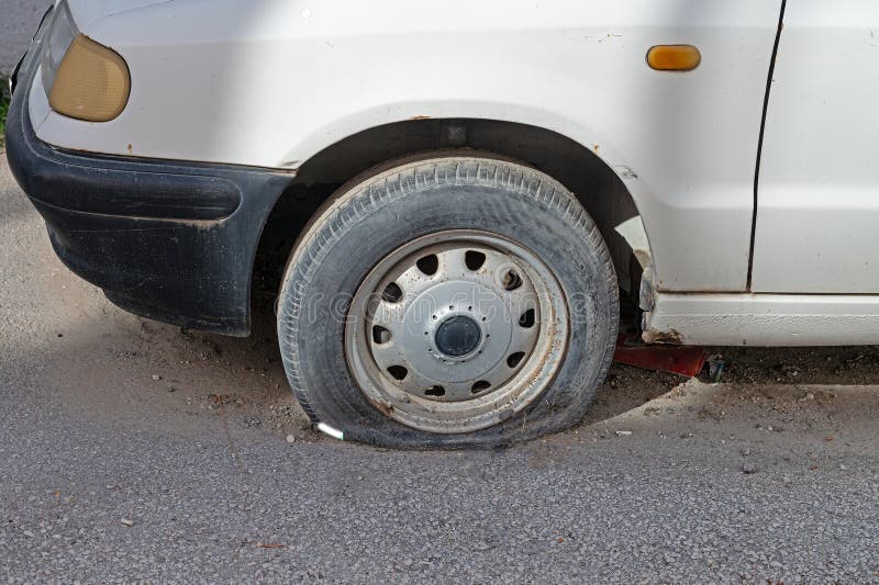 A car with a flat tire stock image. Image of economy - 352523511