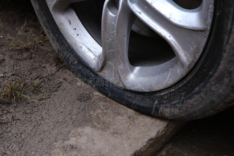 Car Flat Tire. Deflated Wheel of a Car with Alloy Disk Stock Image ...