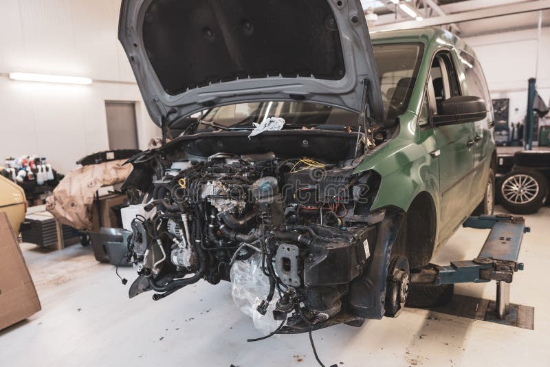 A Car without the Front and without the Hood is Standing in a Garage ...