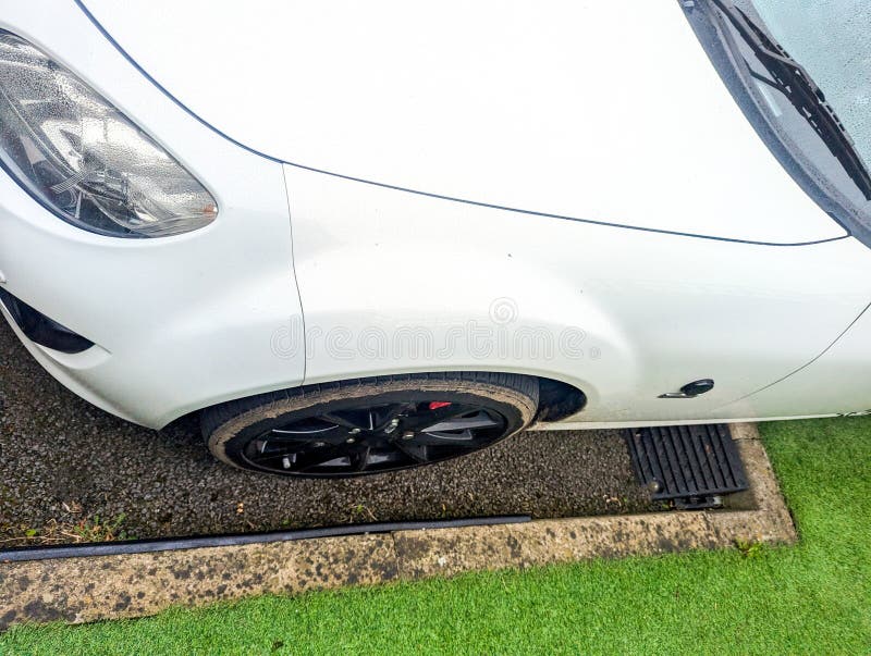 A Car that Has Been Dented by a Thrown Stone an Has Damaged the Body ...