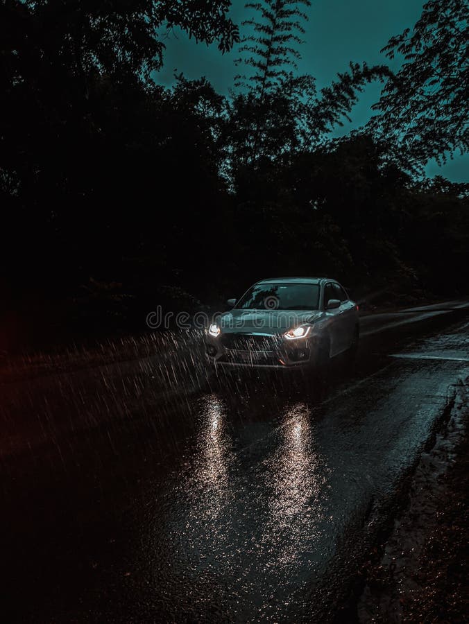 Car Headlights Illuminating Hill at Night during the Rain. Stock Image ...