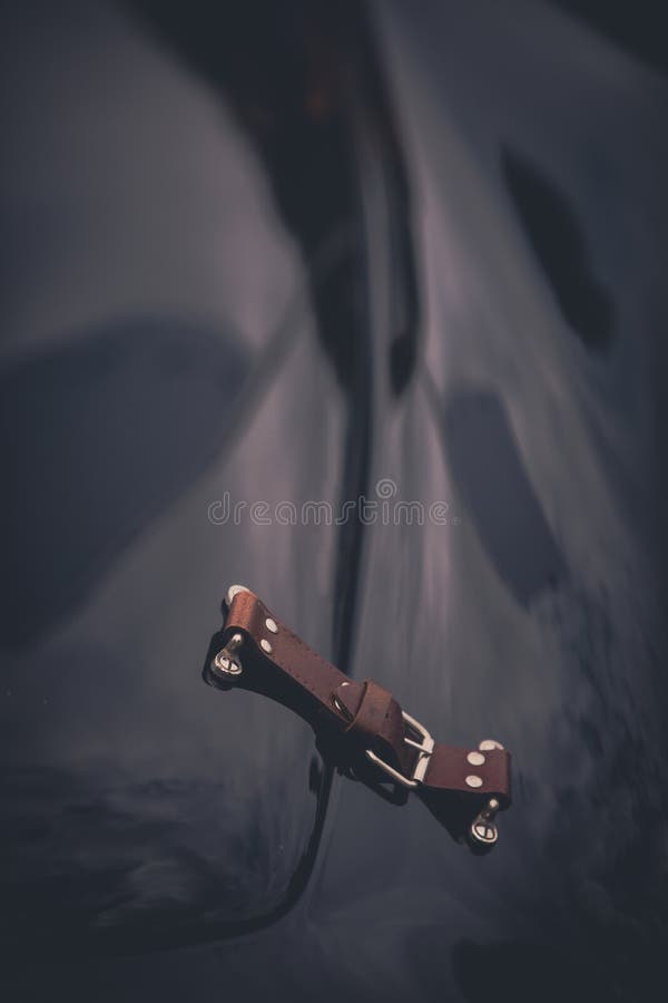 Car hood and leather strap stock photo. Image of used - 163386142