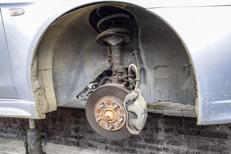 The Car is a Hundred for Repairs. the Wheel is Removed Stock Photo ...