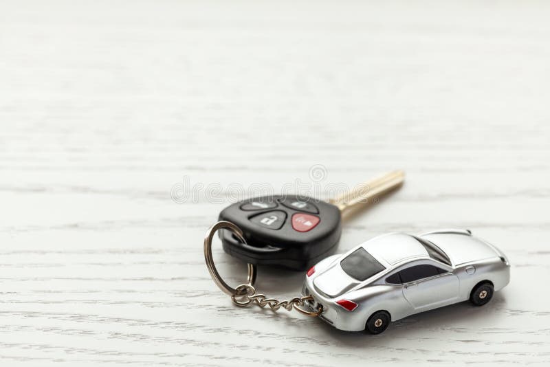 Car Keys with Remote Control Security and Car Key Chain on White Wooden ...