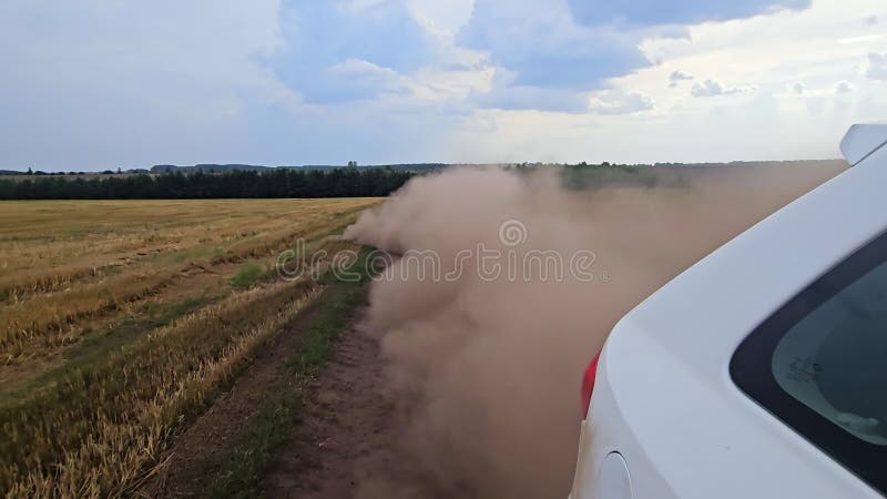 Car Kicking Up Dust on a Rural Dirt Road, Dust Cloud Trailing Behind a ...