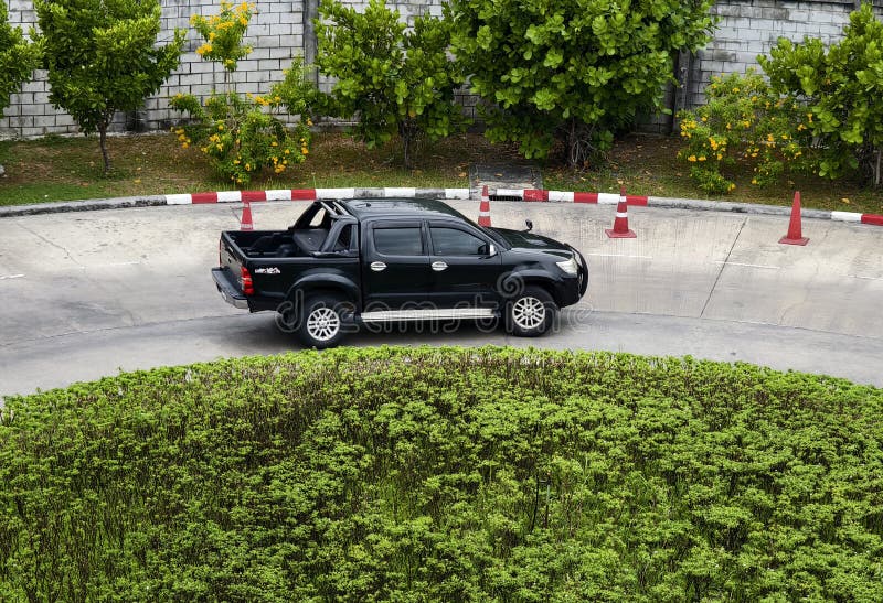 A Car is Maneuvering Around a Curve in a Parking Lot Stock Image ...