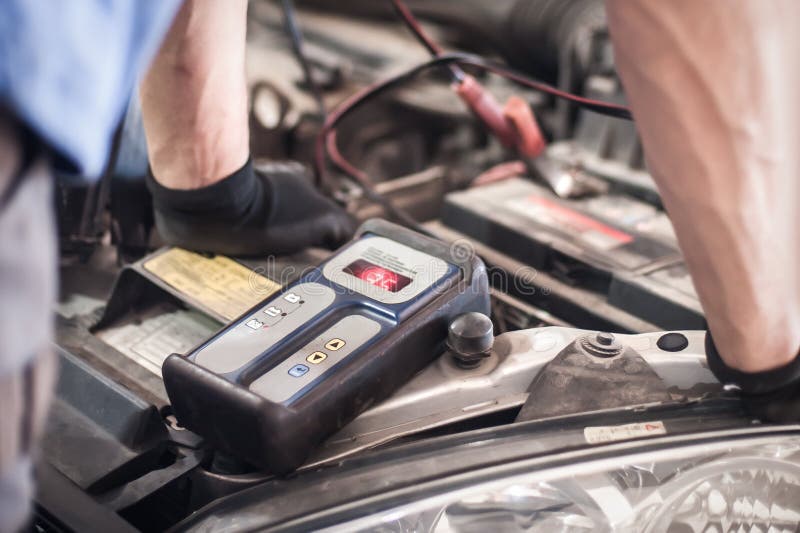 Car Mechanic Checking and Testing Automotive Accumulator with Battery ...