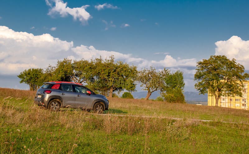 Car in the Meadow with Trees and Blue Sky Behind Editorial Stock Photo ...