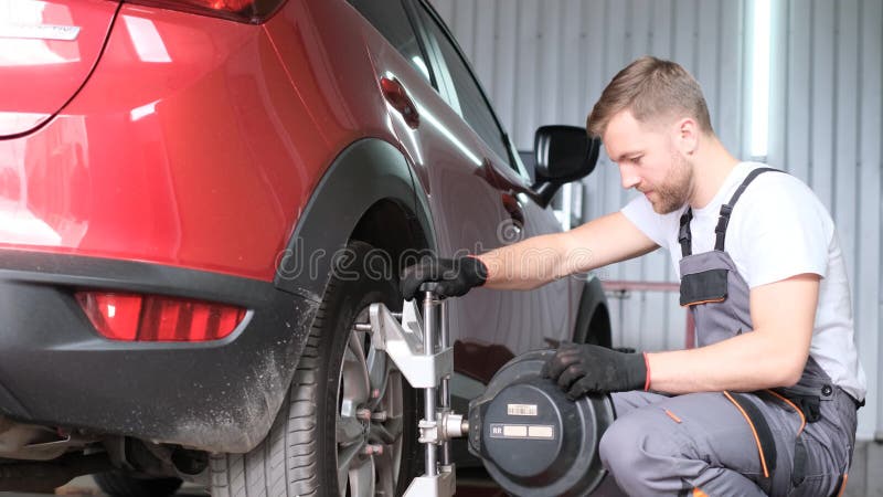 The Car Mechanic Adjusts the Car Control System. Car Service. Diagnosis ...