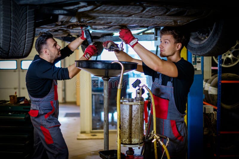 Car Mechanic Changes Oil in a Workshop Stock Image - Image of hand ...