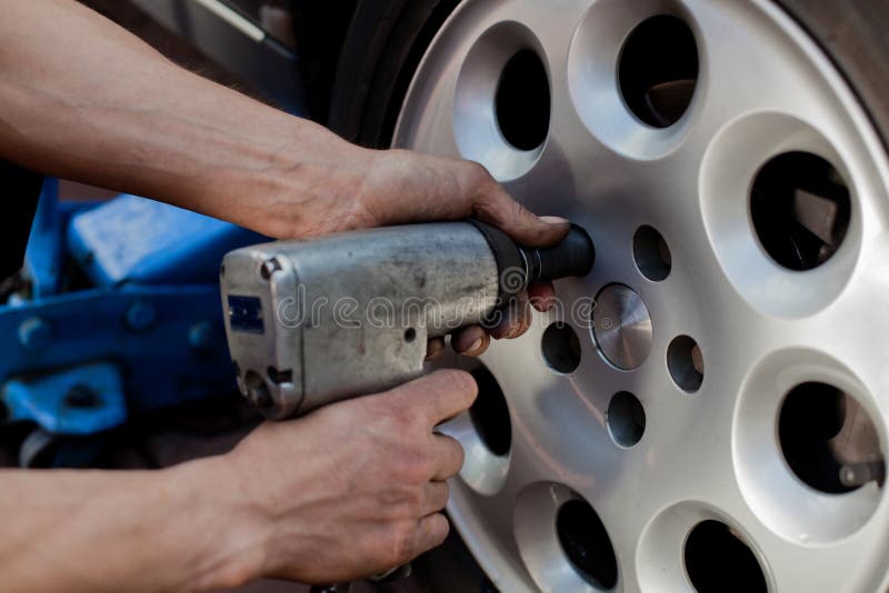 Car Mechanic Changing Wheel Stock Image - Image of holding, alloy: 25040029