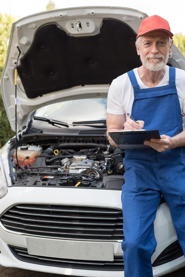 Car Mechanic Checking a Car Engine Stock Photo - Image of professional ...