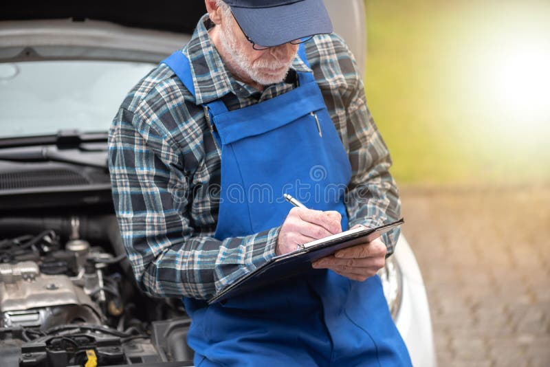 Car Mechanic Checking a Car Engine Stock Image - Image of checking ...