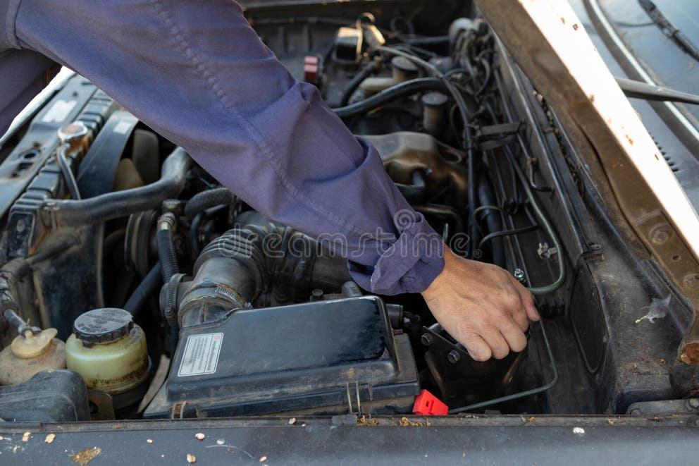 Car Mechanic is Checking Condition of Engine To Make it Ready for Use ...