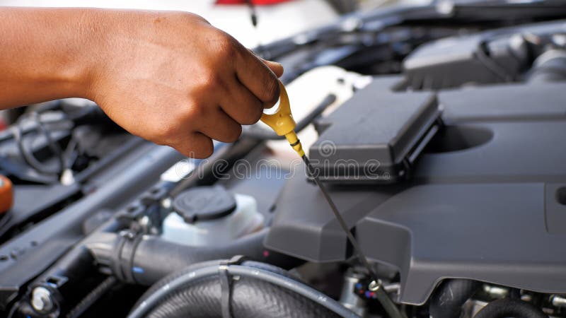 Car Mechanic Checking Car Engine Oil Level and Car Engine Oil Quality ...