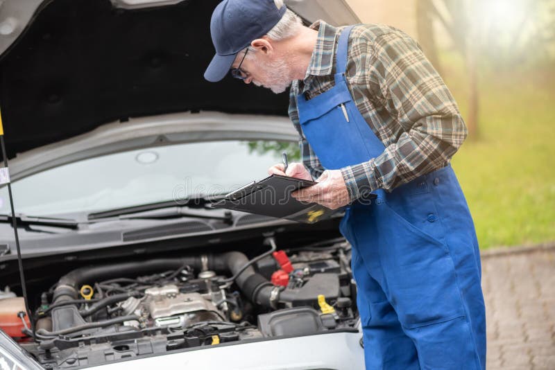 Car Mechanic Checking a Car Engine Stock Photo - Image of check, male ...