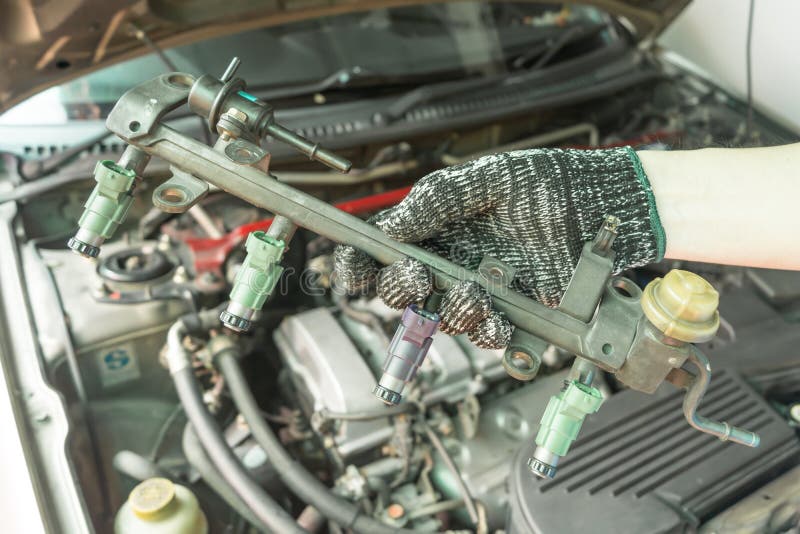 Car Mechanic Checking Fuel Injector System, Car Maintenance Service ...