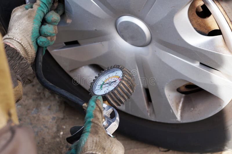 Car Mechanic Checks the Pressure in the Car Wheel Stock Image - Image ...
