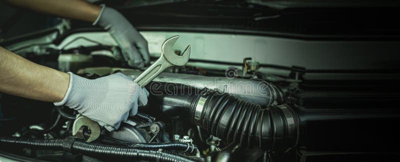 A Car Mechanic is Doing a Car Repair in a Repair Shop Stock Photo ...