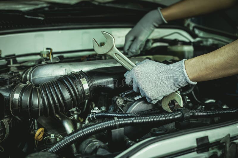 A Car Mechanic is Doing a Car Repair in a Repair Shop Stock Photo ...