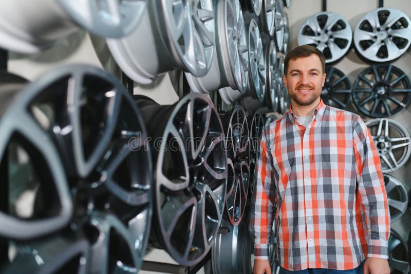 Car Mechanic Holding Car Rims Ready To Mount the Wheels in Workshop ...