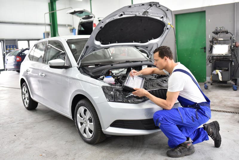 Car Mechanic Inspects Vehicle in a Workshop Stock Photo - Image of ...