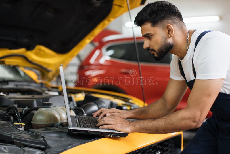 Car Mechanic Maintains Vehicle Using Diagnostic Laptop Computer for ...