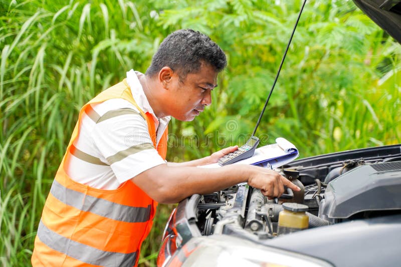 Car Mechanic Performs Basic Engine Check and Carrying a Clipboard Stock ...