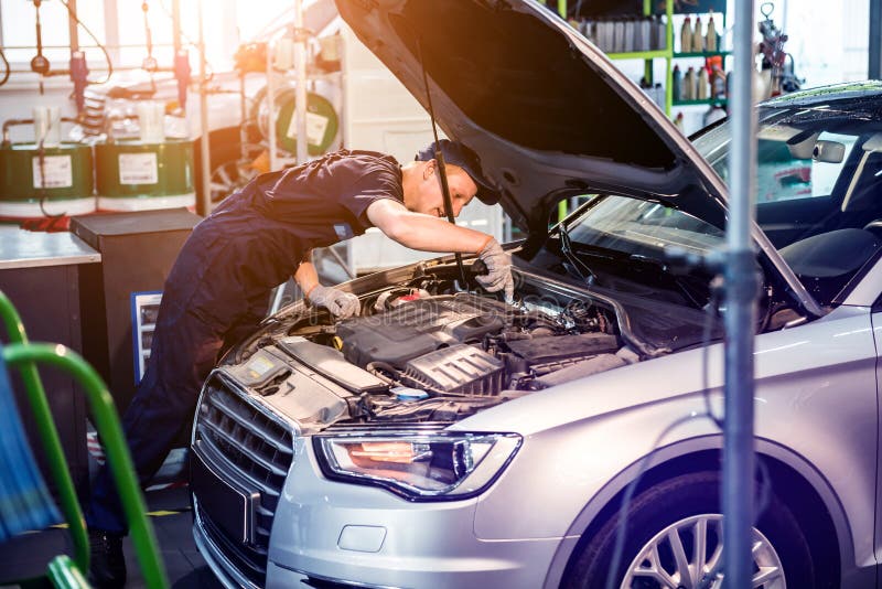 Car Mechanic Repair Engine at Service Station. Car Repair Stock Photo ...