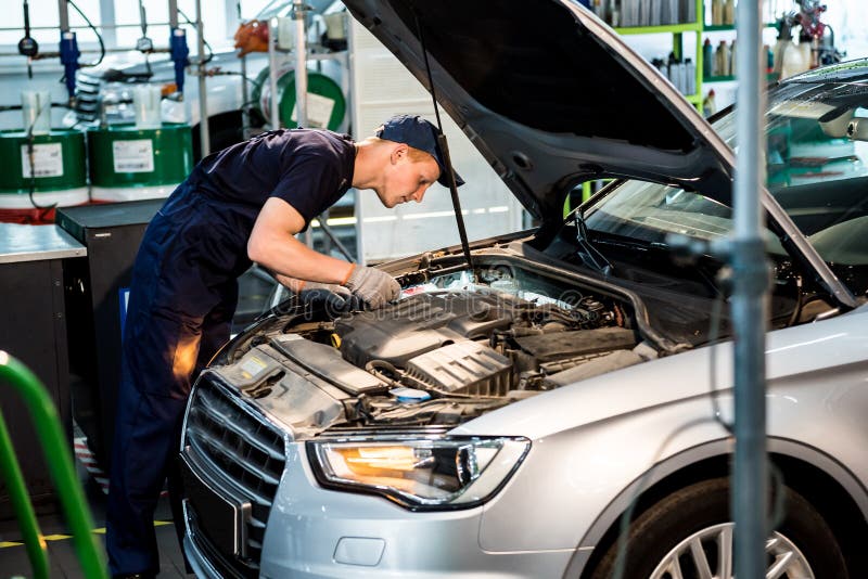 Car Mechanic Repair Engine at Service Station. Car Repair Stock Photo ...