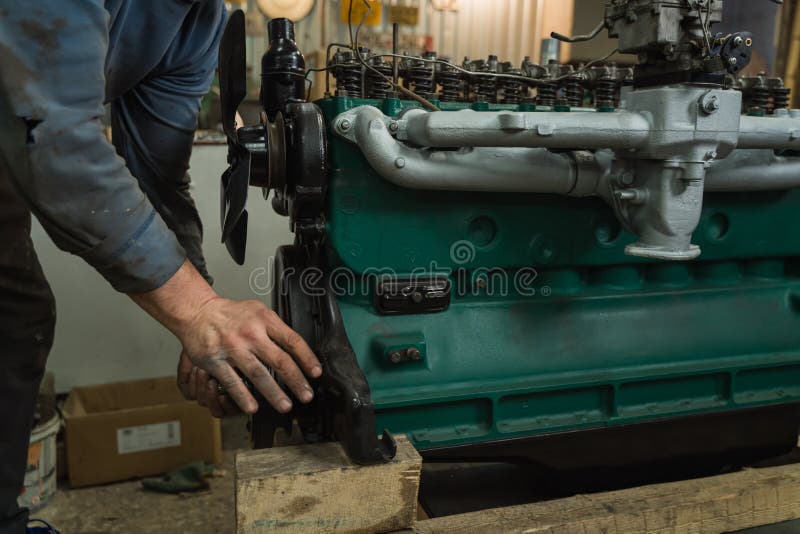 Car Mechanic Repairing an Engine. Mechanic Working on Car Engine ...