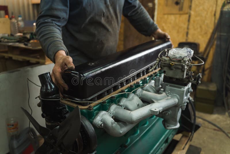 Car Mechanic Repairing an Engine. Mechanic Working on Car Engine ...