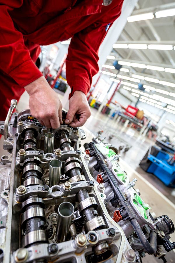 A Car Mechanic Repairs an Engine in a Car Service. Stock Photo - Image ...