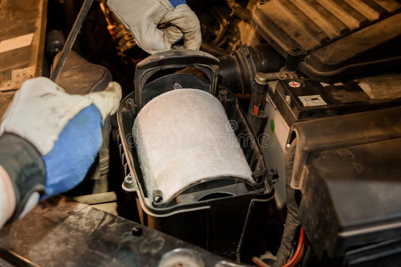 Car Mechanic Replacing Air Filter in Engine Compartment Stock Image ...