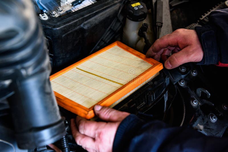 Car Mechanic Replacing Old Paper Air Filter of Car and Installing New ...