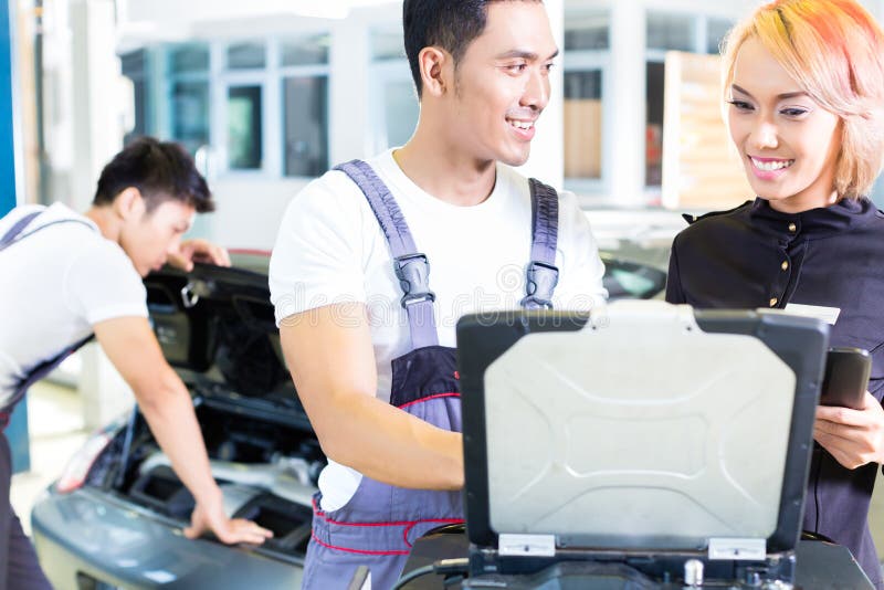 Mechanic Team Working in Car Workshop Stock Image - Image of team ...