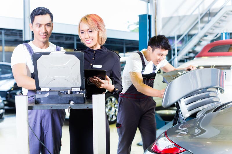 Mechanic Team Working in Car Workshop Stock Image - Image of team ...
