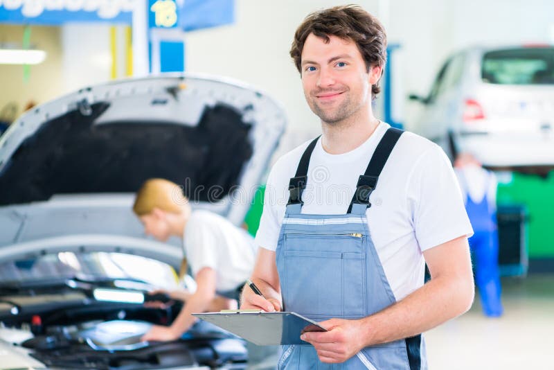 Mechanic Team Working in Car Workshop Stock Image - Image of team ...