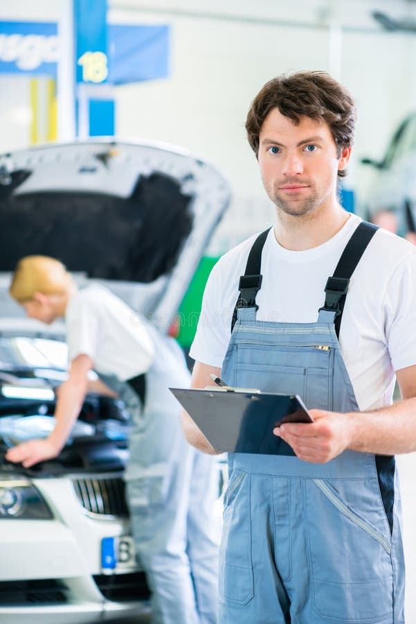 Mechanic Team Working in Car Workshop Stock Image - Image of auto, shop ...